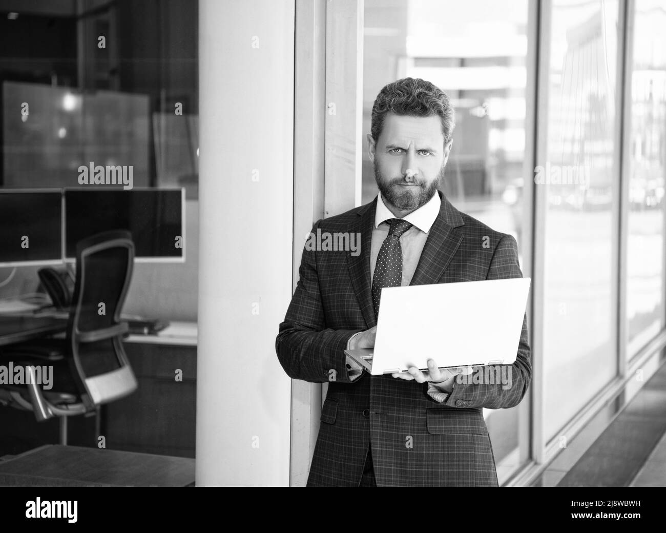 boss with modern wireless laptop. mature businessman working online. business success Stock ...