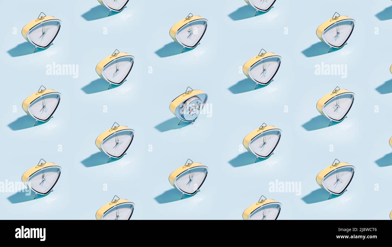 Many vintage alarm clocks pattern on blue background Stock Photo - Alamy