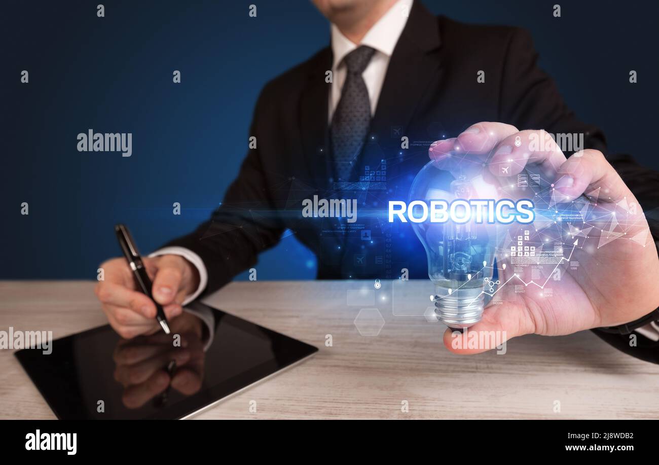 Businessman holding a light bulb Stock Photo - Alamy