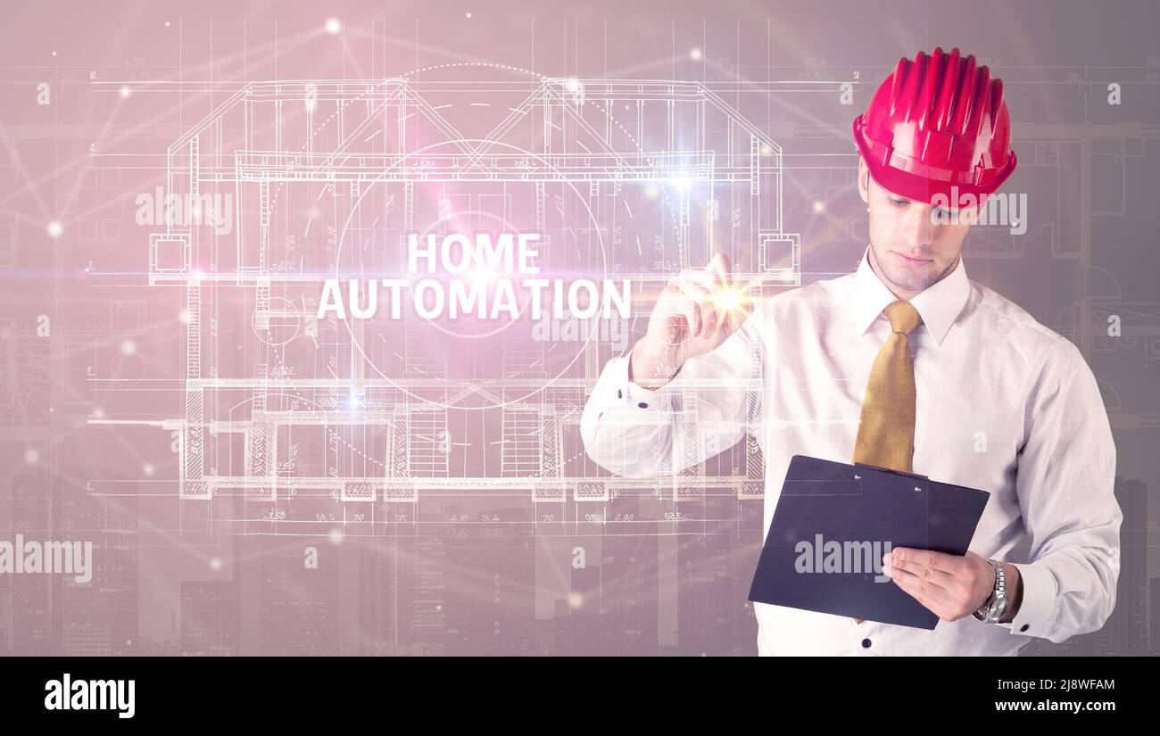 Handsome architect drawing with helmet Stock Photo - Alamy