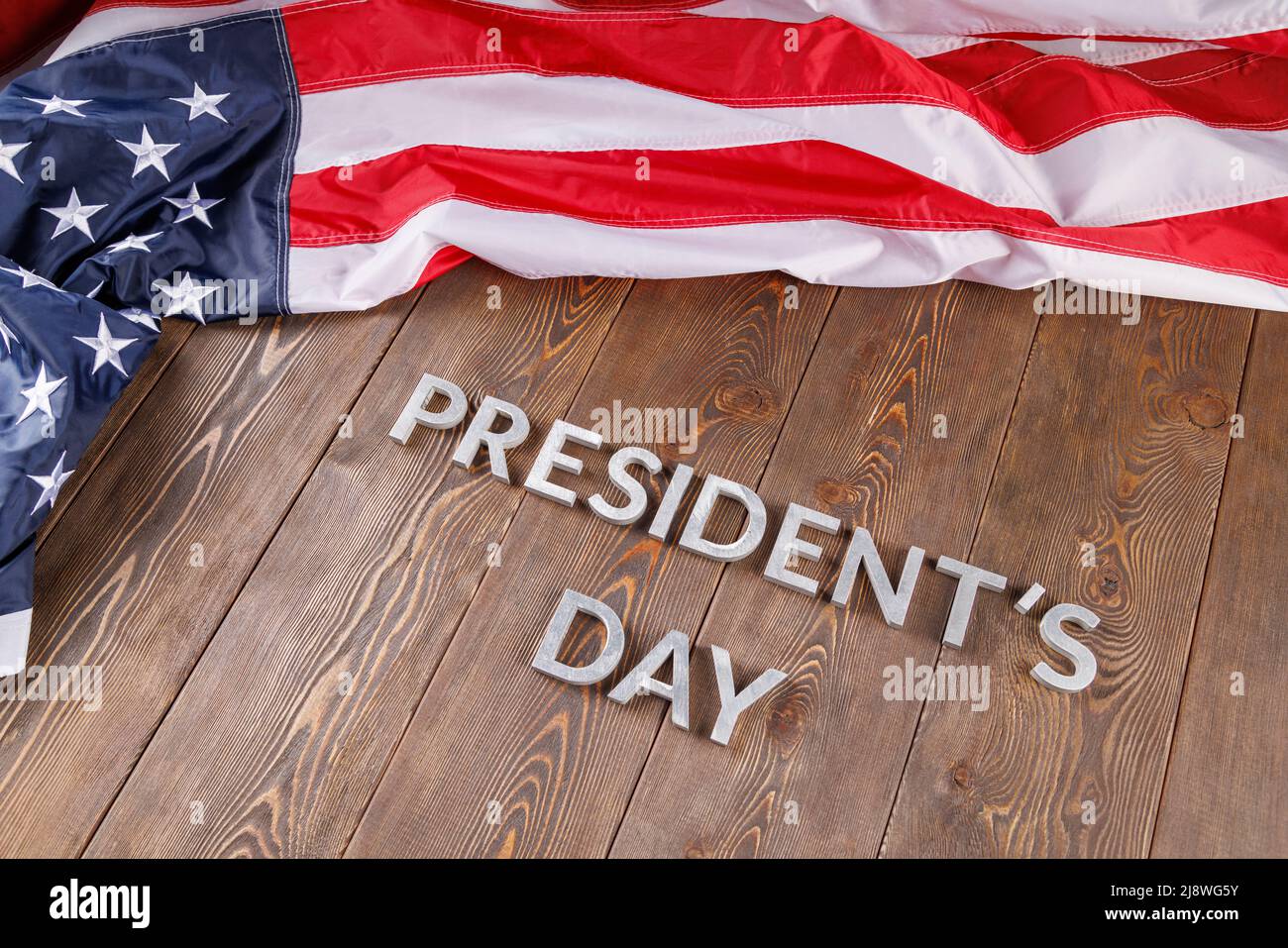 words presitdents day laid with silver letters on wooden surface near ...
