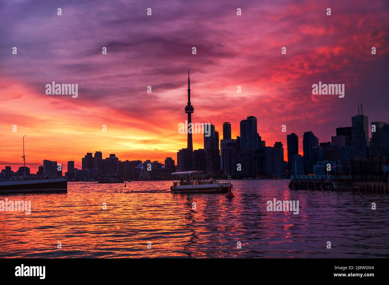 Summer sunset view from Toronto Islands across the Inner Harbour of the ...