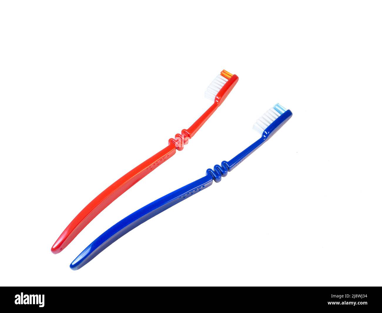 Two toothbrushes lie on a white background. Blue and red toothbrushes ...