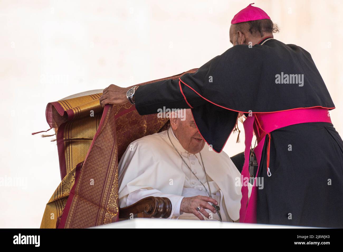 Vatican, Vatican. 18th May, 2022. Pope Francis is being helped to wear ...