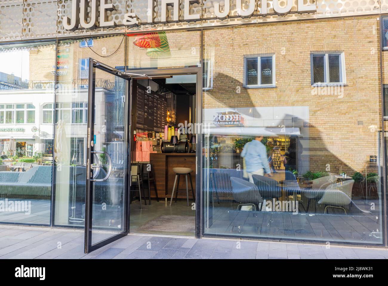 Beautiful exterior view of modern city cafe with open door. Sweden ...