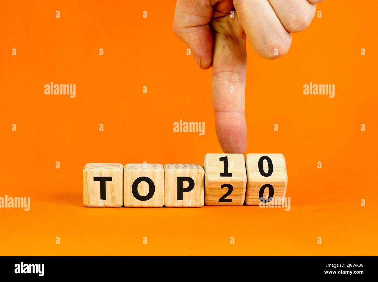 From Top 20 to 10 symbol. Businessman turns wooden cubes and changes ...