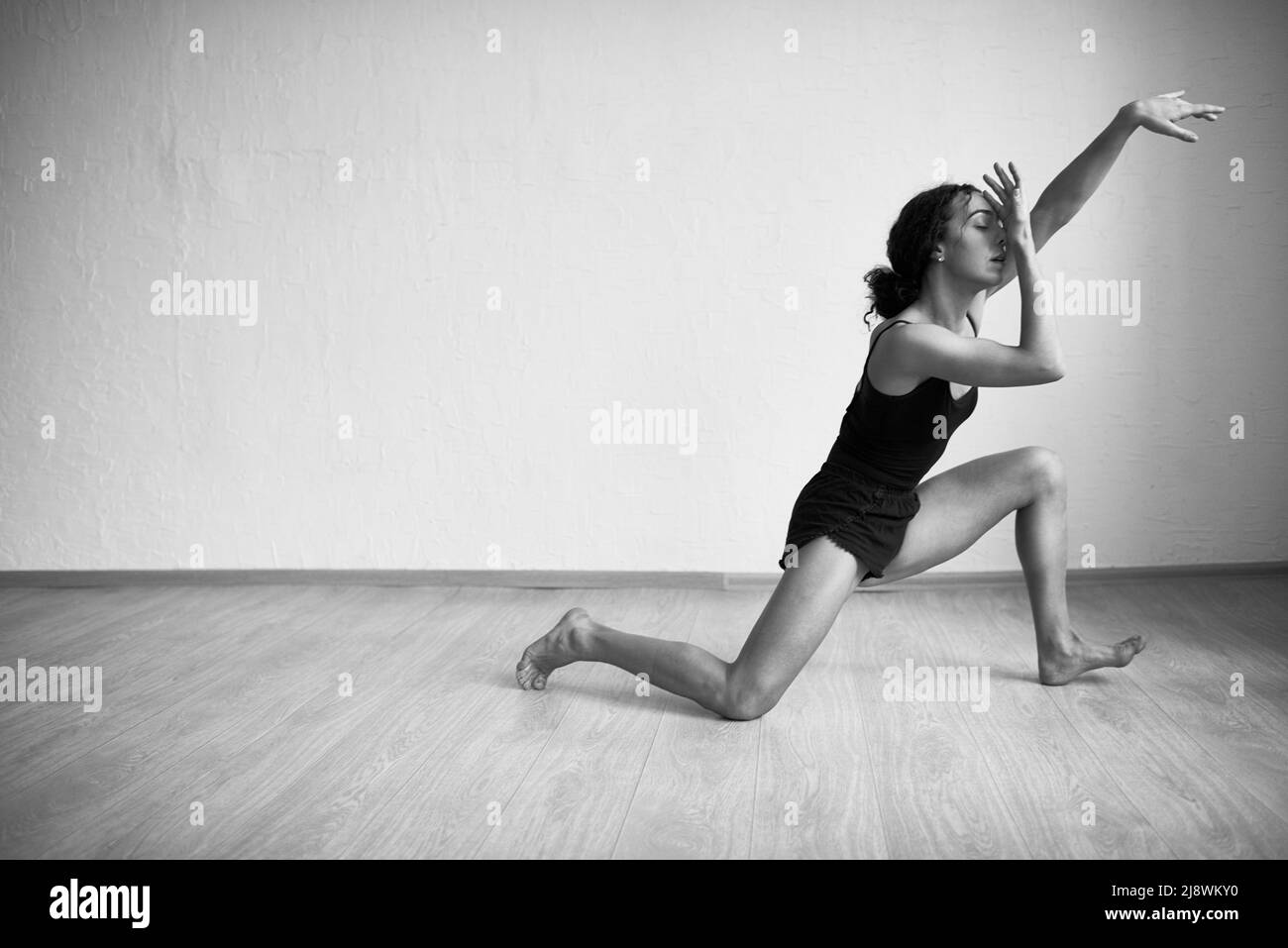 Black and white shot of young attractive slim woman performing ...