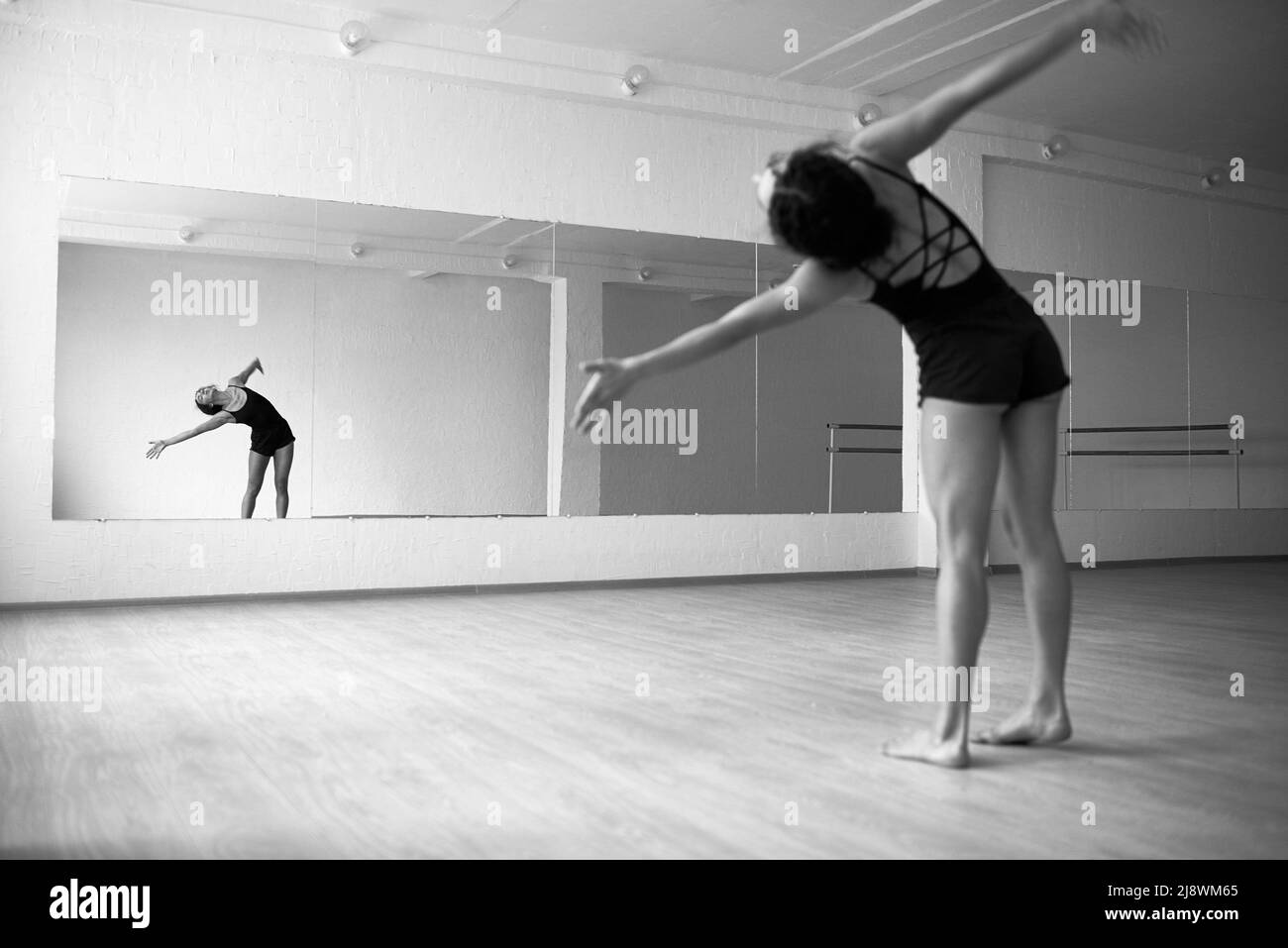 Black and white photo of young woman performing emotional dance in ...
