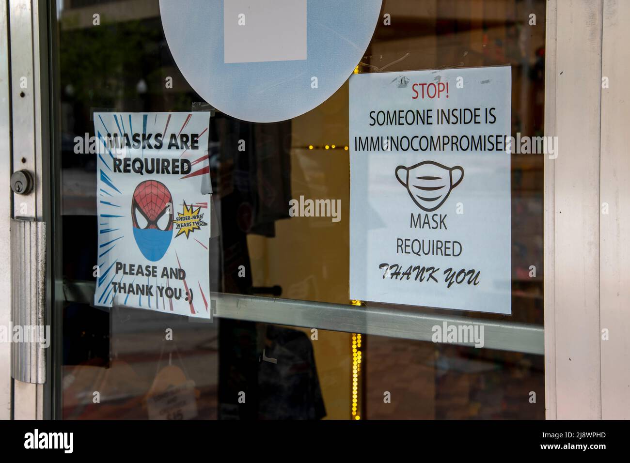 Lawrence, Kansas. Facemasks are required sign in store window and ...