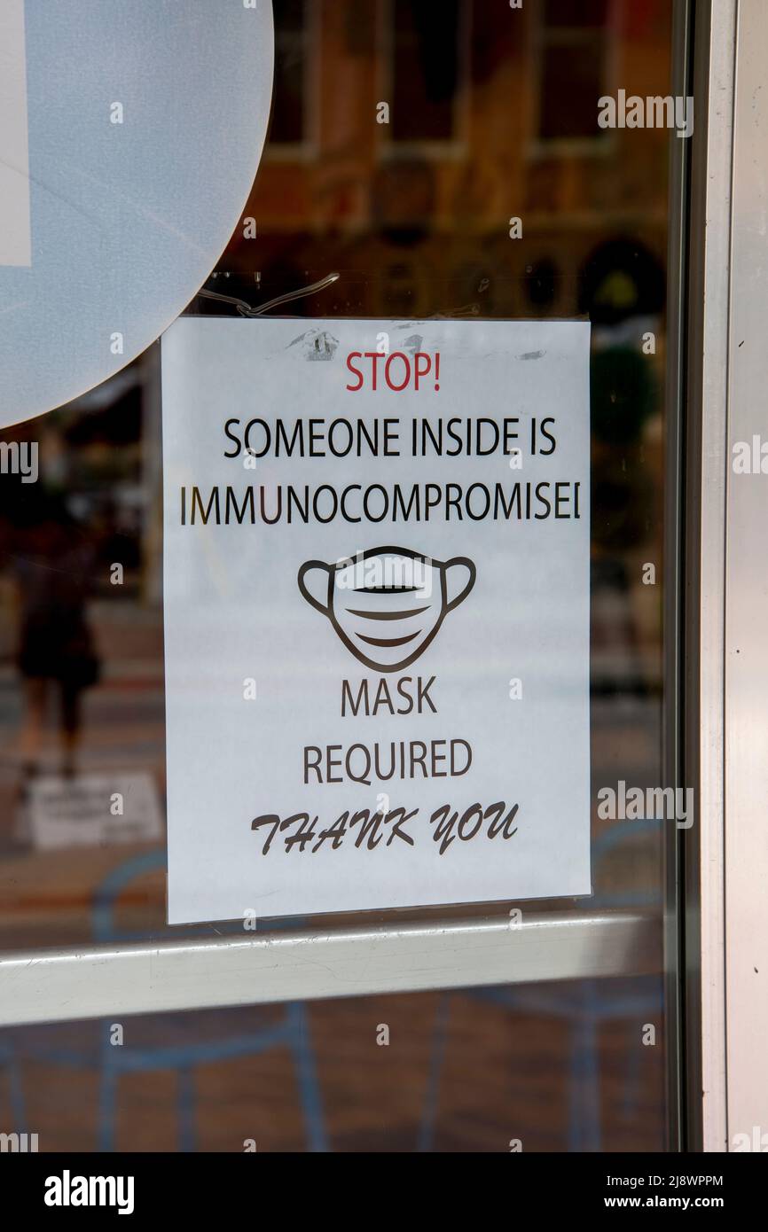 Lawrence, Kansas. Facemasks are required sign in store window and ...
