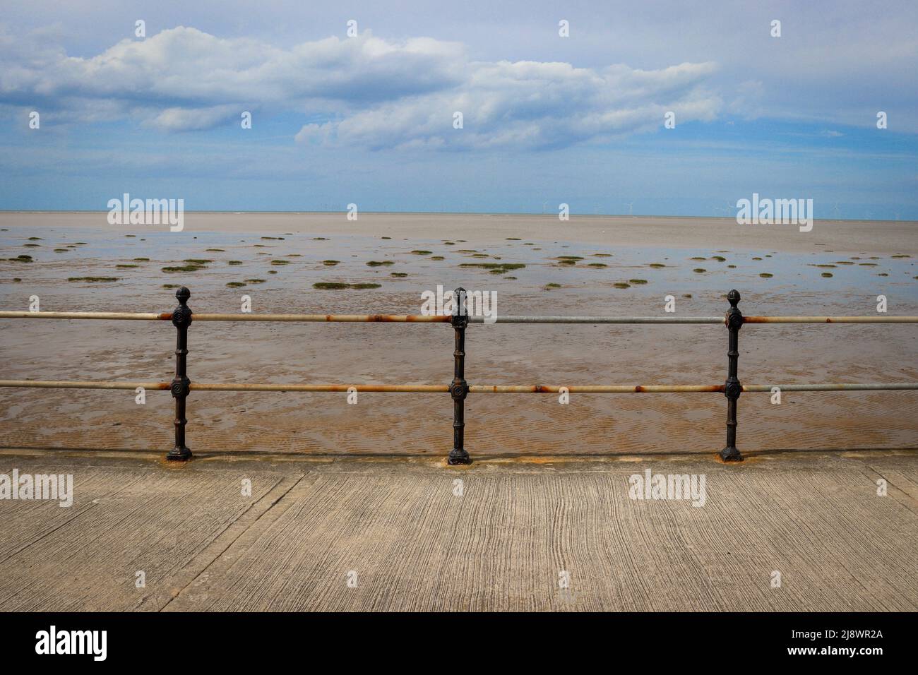 Tide out at Hoylake Beach - with grass mounds / patches Stock Photo - Alamy