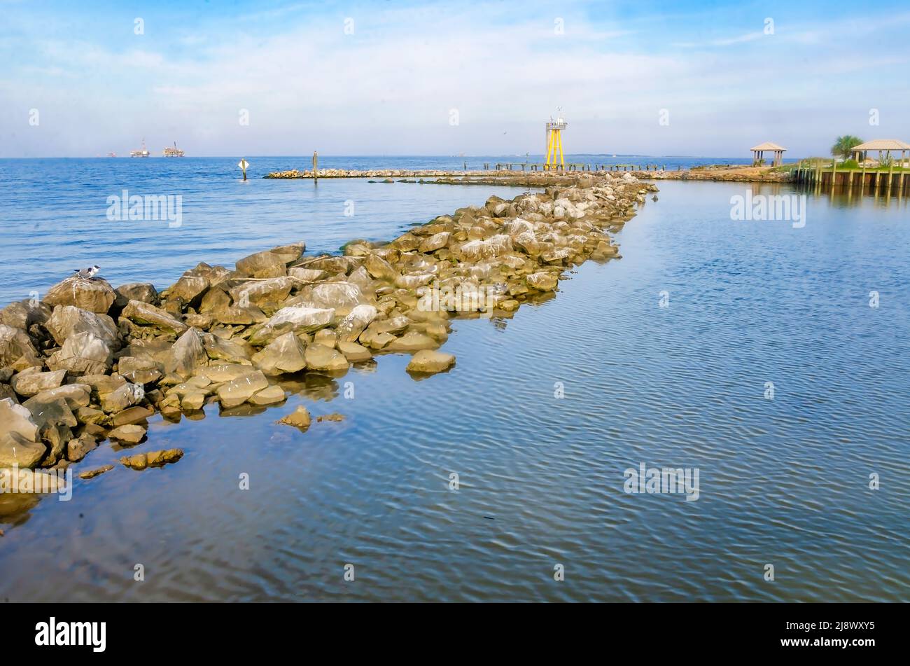 A rock jetty creates a protected inlet, April 28, 2022, in Dauphin ...