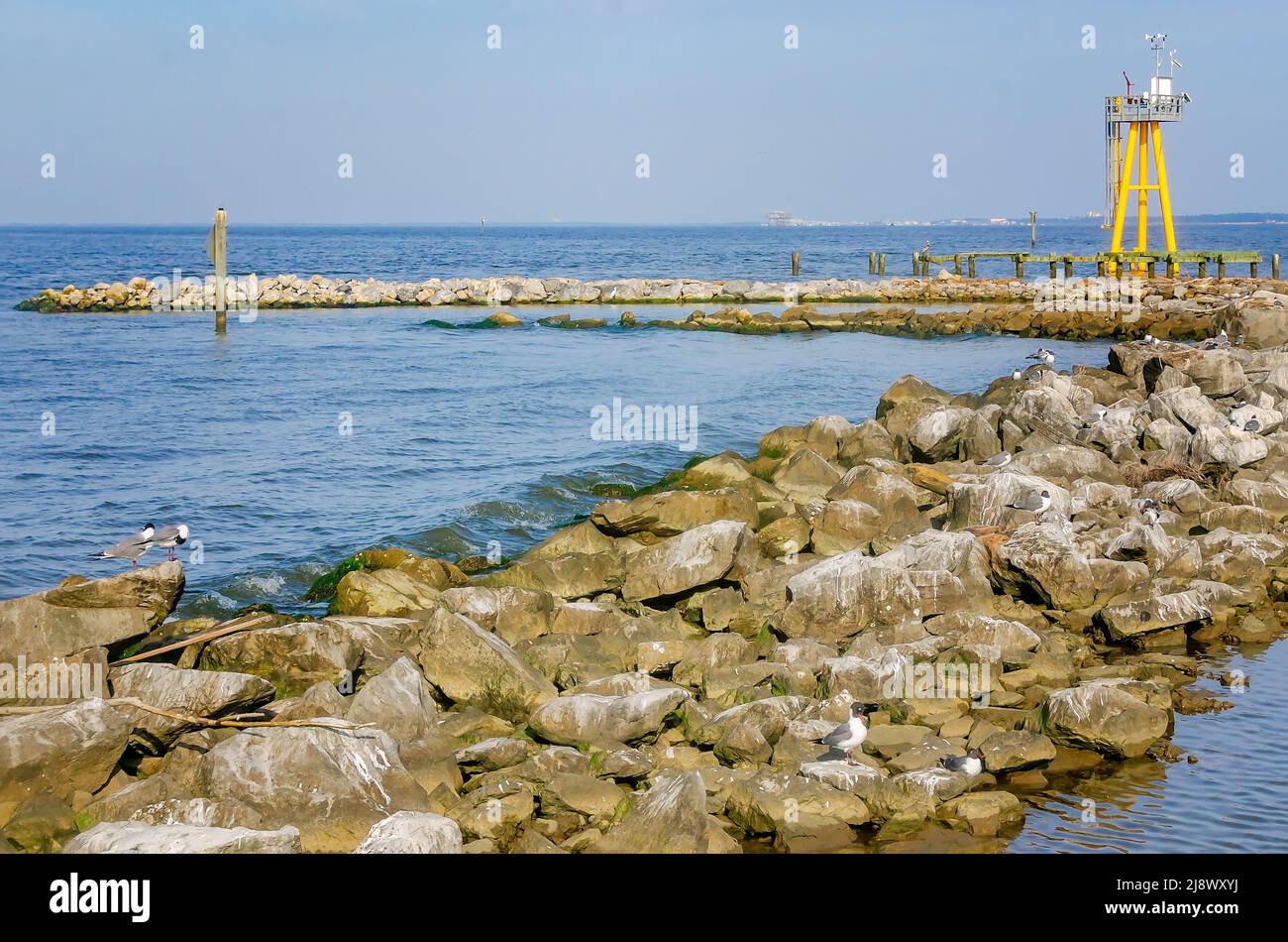 A rock jetty creates a protected inlet, April 28, 2022, in Dauphin ...