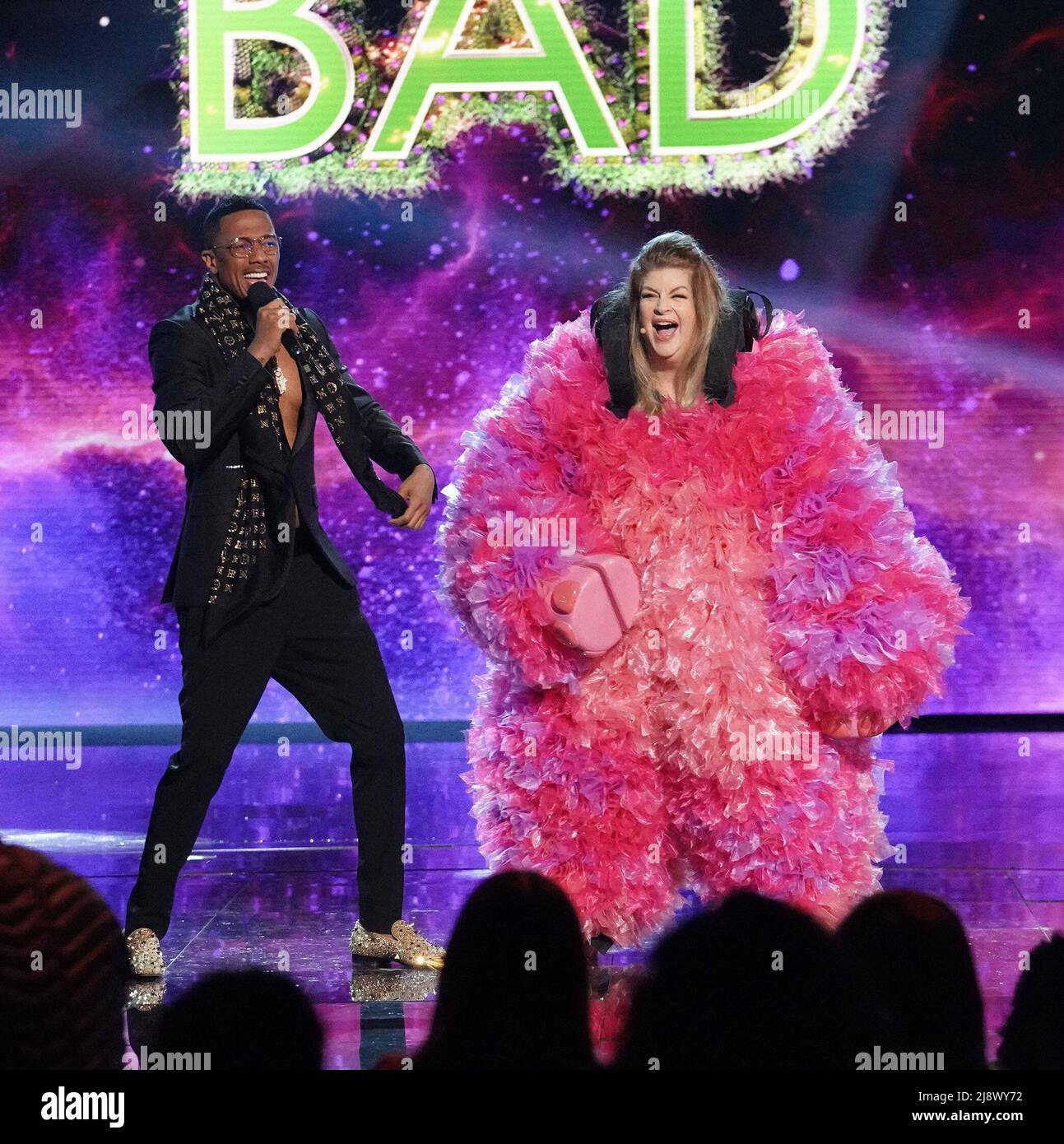 THE MASKED SINGER, from left: host Nick Cannon, Kirstie Alley (revealed ...