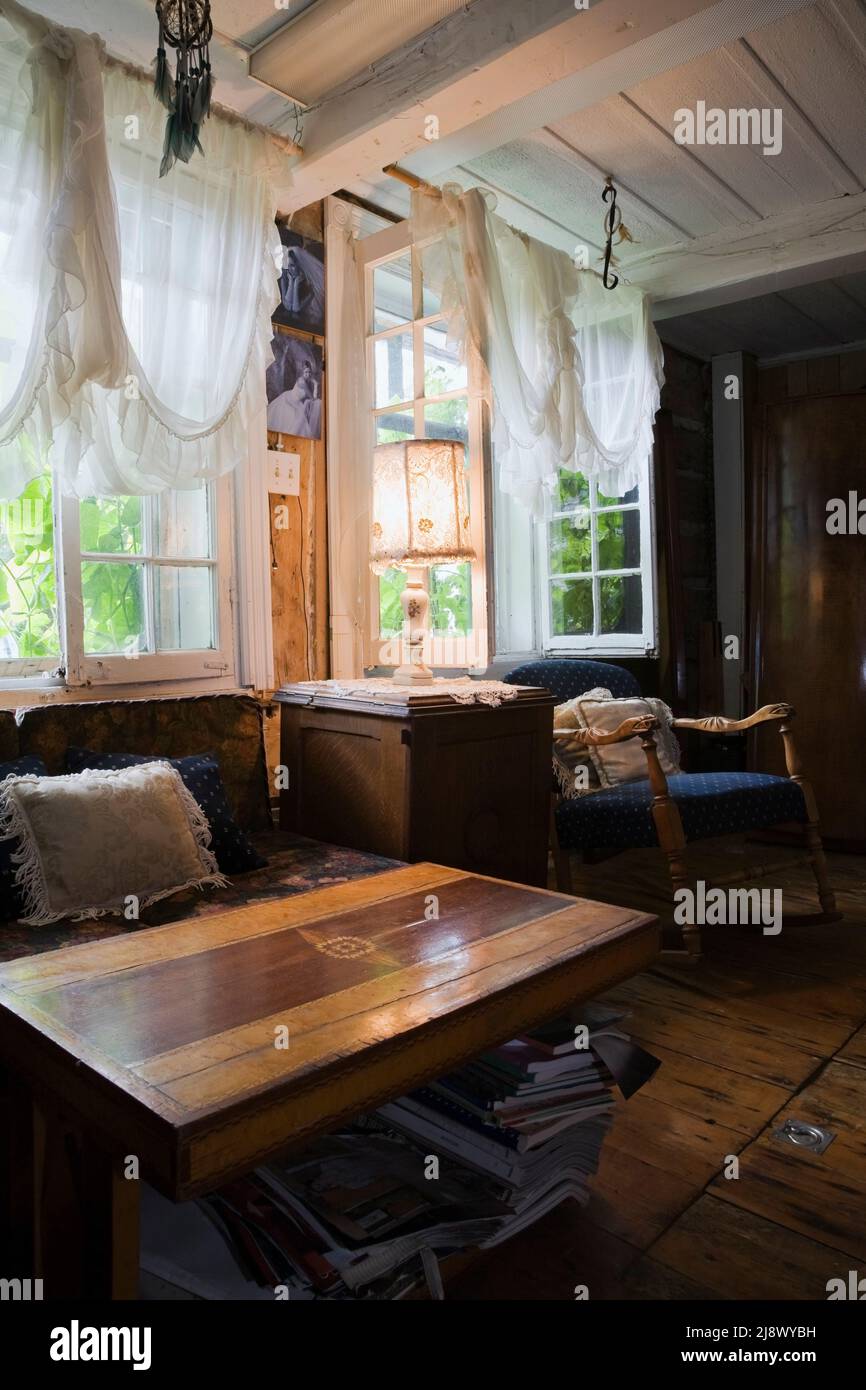 Coffee table, sofa and rocking chair in living room inside old circa ...