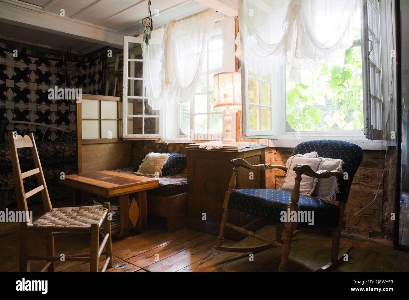 Coffee table, sofa and rocking chair in living room inside old circa ...