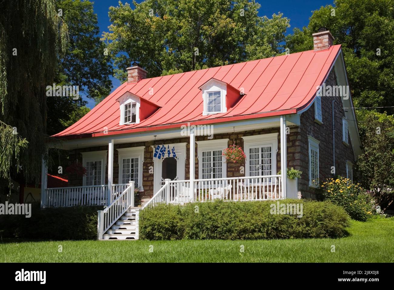 Old 1831 Canadiana cottage style quarry stone home with orange sheet ...