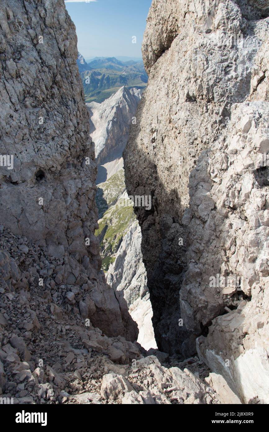 The view of mountain landscape seeing through a narrow gap in the rocks ...