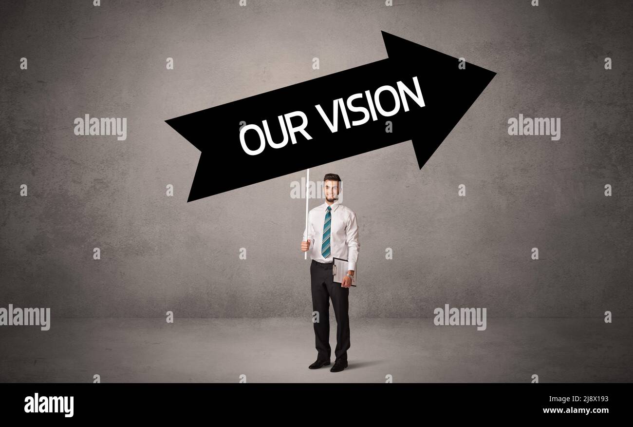 Young business person in casual holding road sign Stock Photo - Alamy