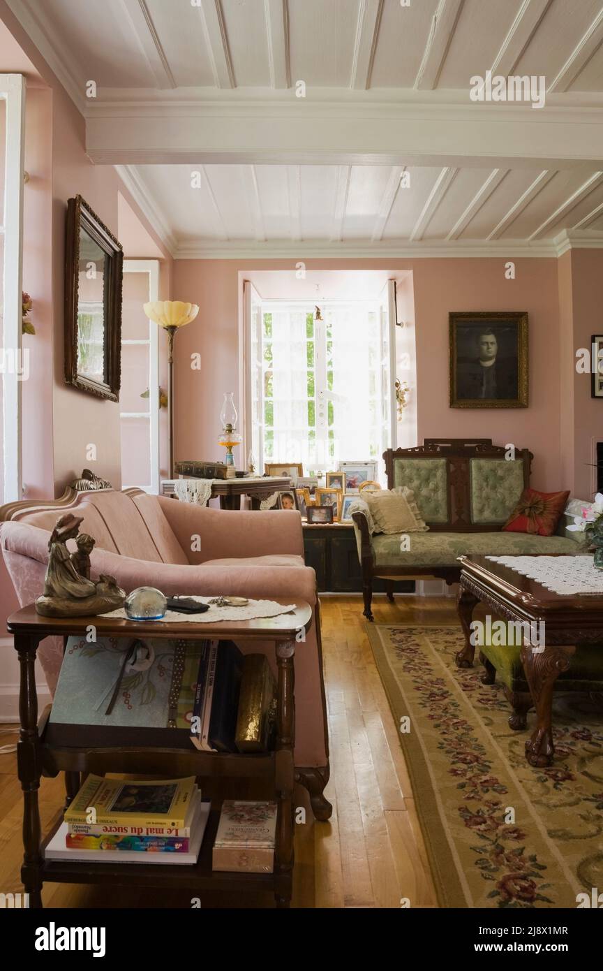 Antique furniture and furnishings in pink painted living room inside ...