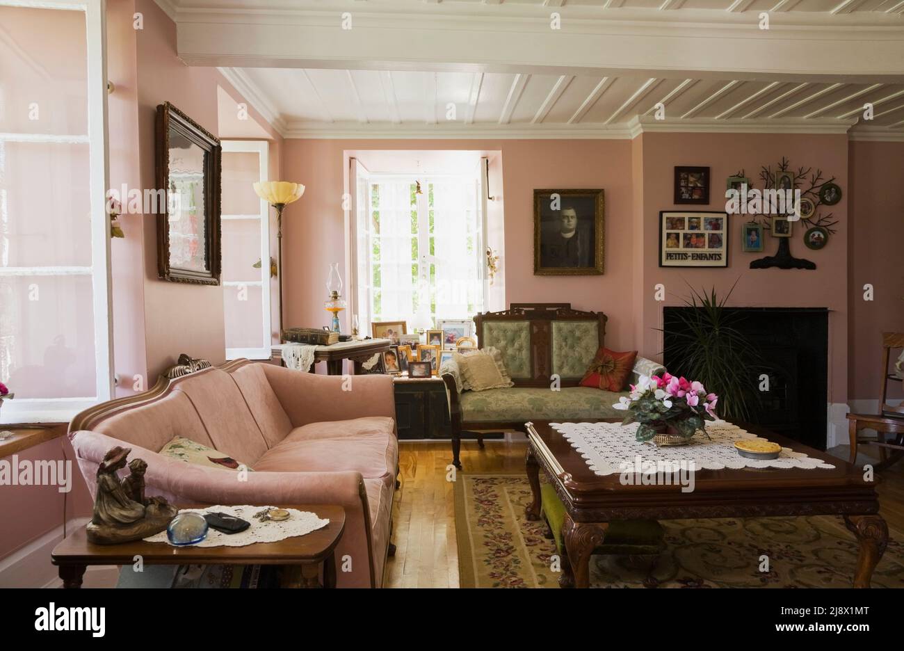 Antique furniture and furnishings in pink painted living room inside ...