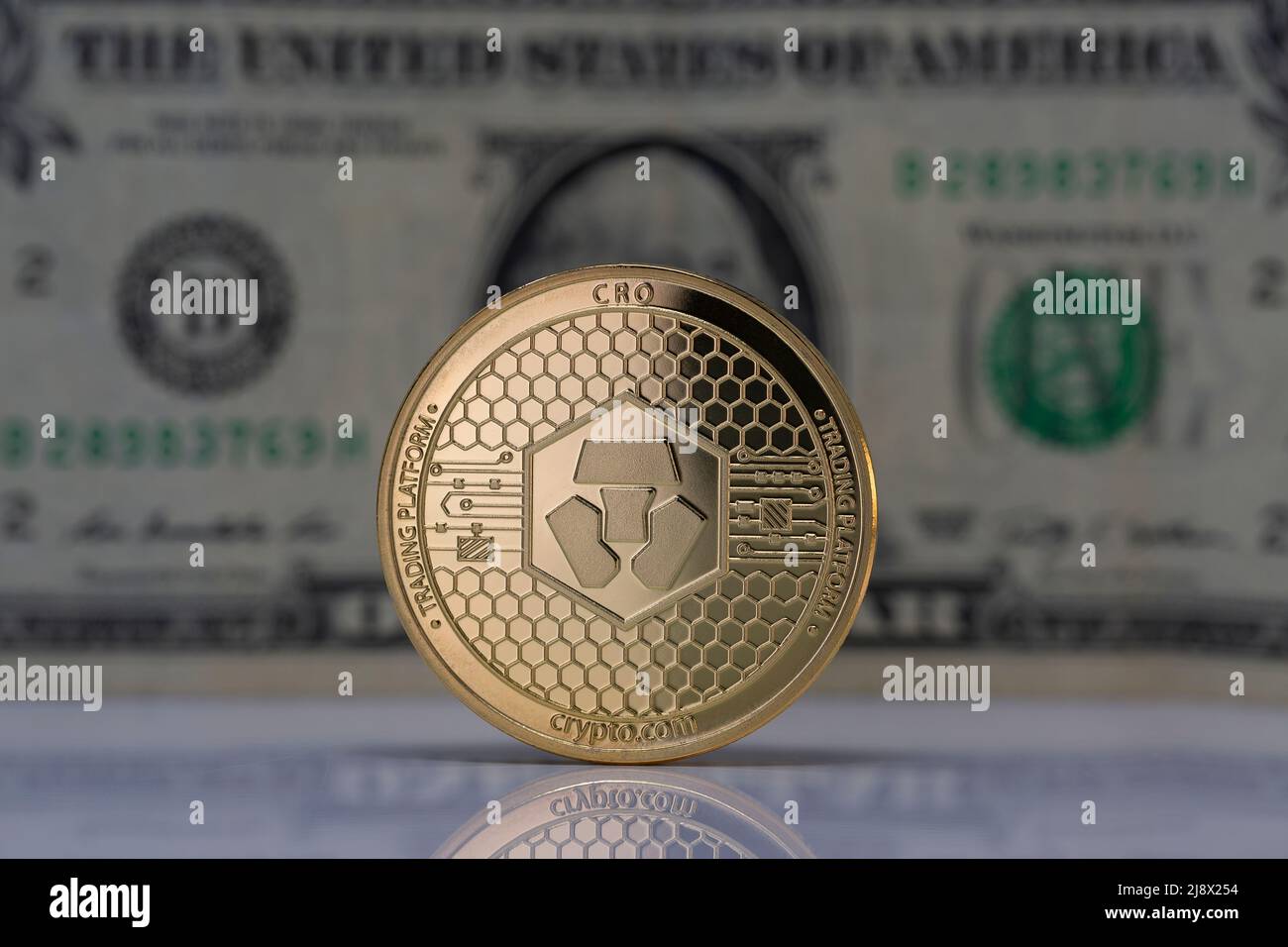 CRONOS CRO Cryptocurrency Physical Coin placed on reflective surface ...