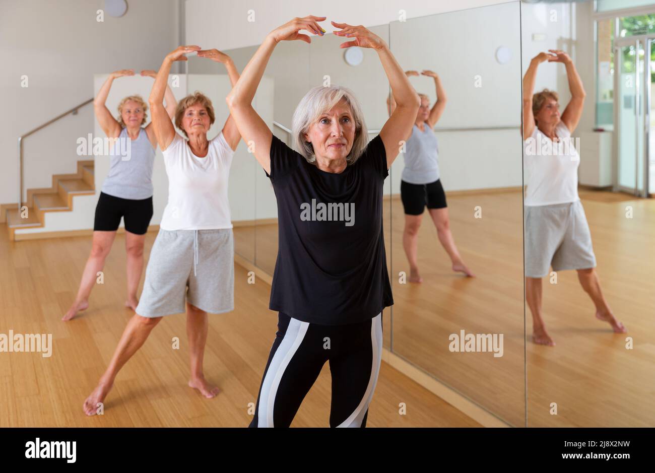 Mature active women perform ballet exercises in the studio Stock Photo ...