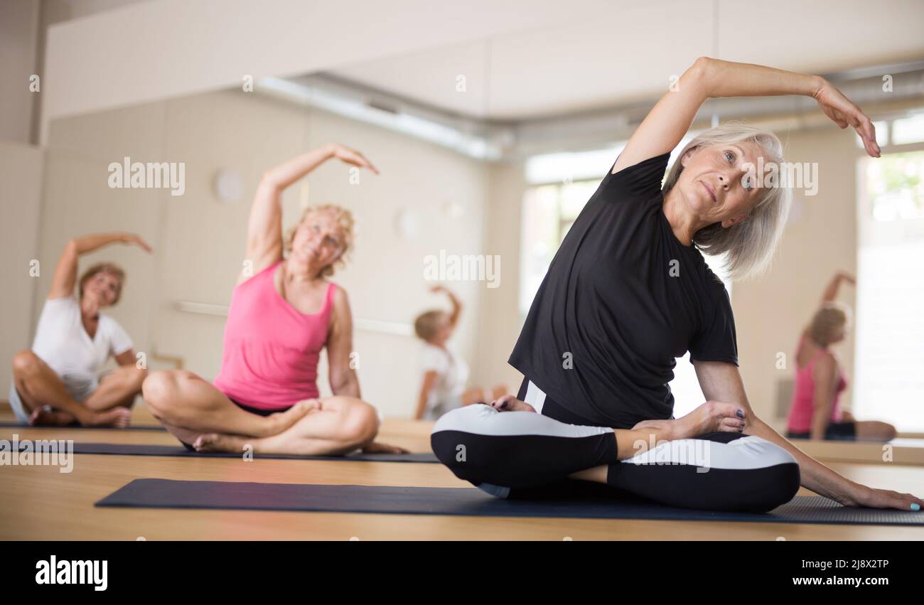 Elderly women practicing yoga trainin the lotus position Stock Photo ...
