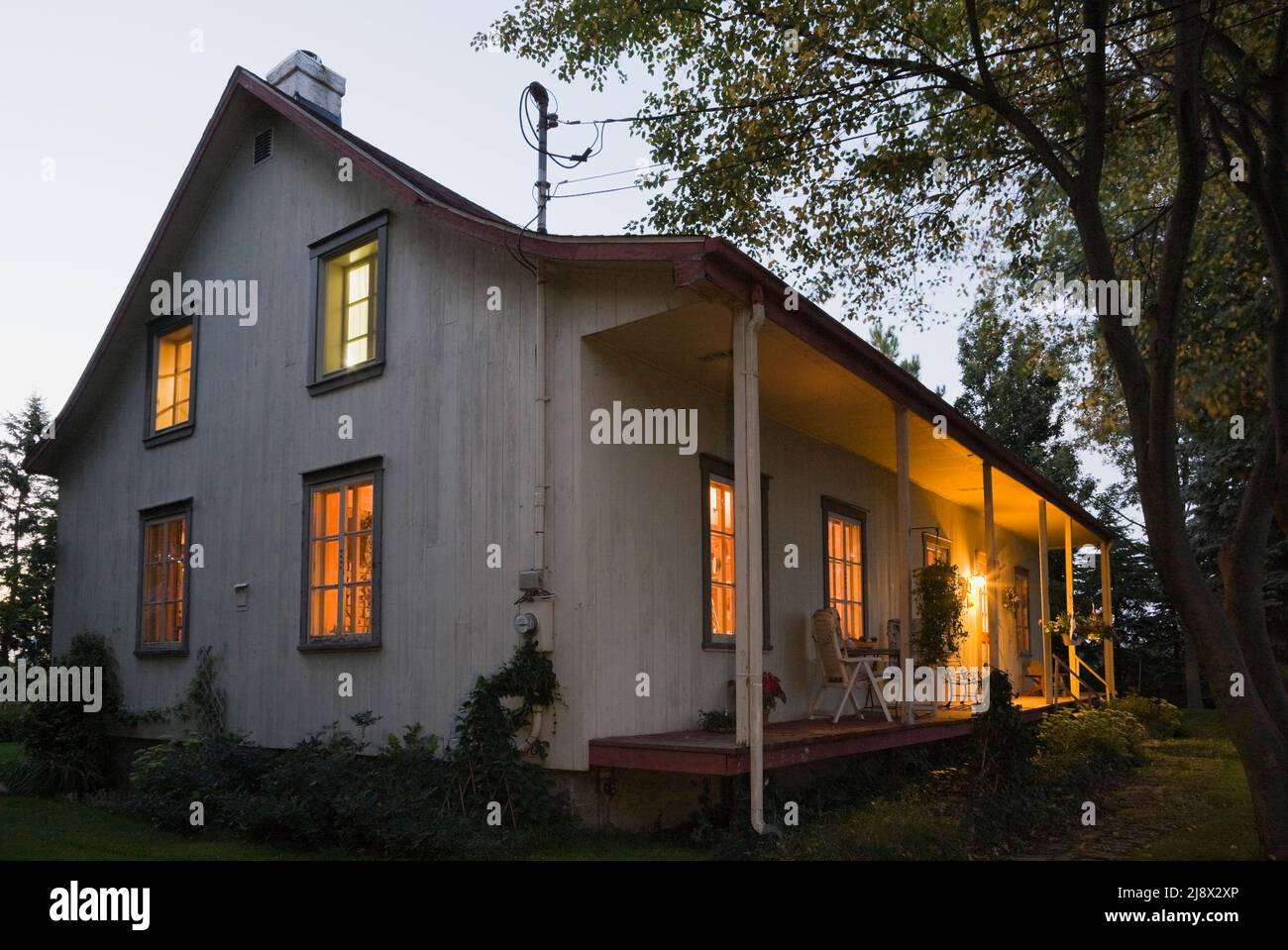 Old circa 1859 Canadiana cottage style home facade with wood plank ...
