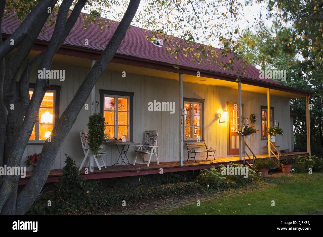 Old circa 1859 Canadiana cottage style home facade with wood plank ...