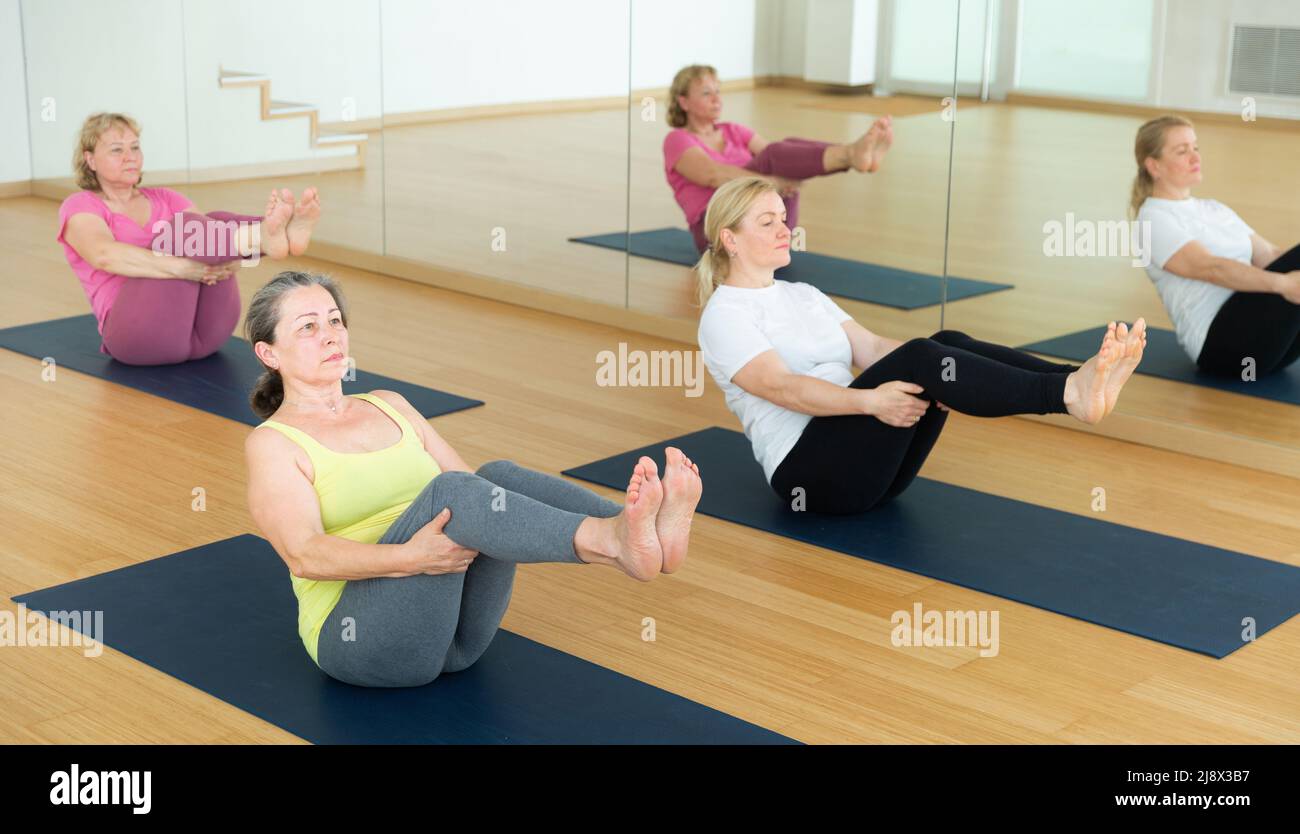 Active senior women practicing balancing yoga poses Stock Photo - Alamy