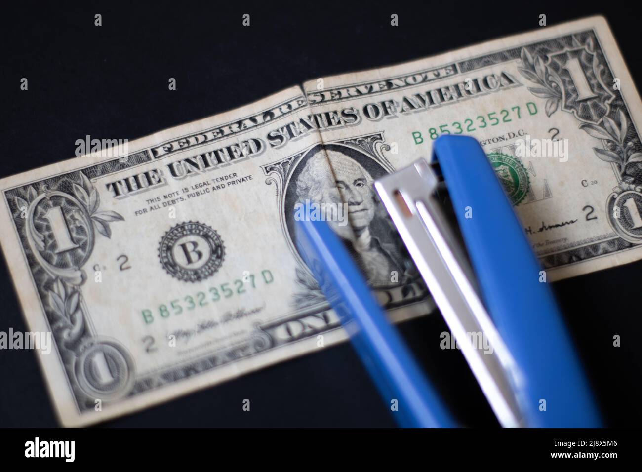 An effort to fix a worn-out dollar with a stapler Stock Photo - Alamy