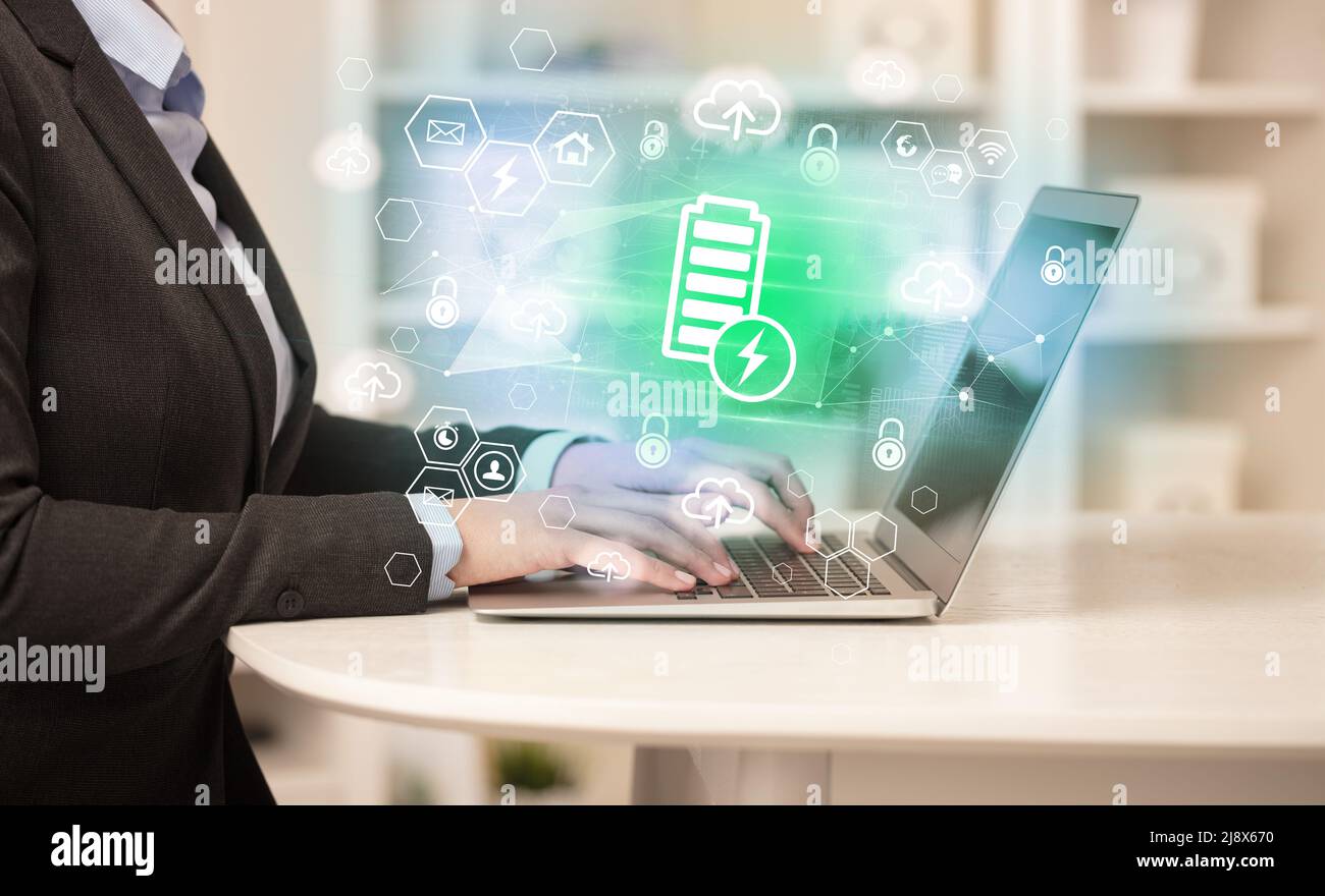 Hands working on laptop with digital icons Stock Photo - Alamy