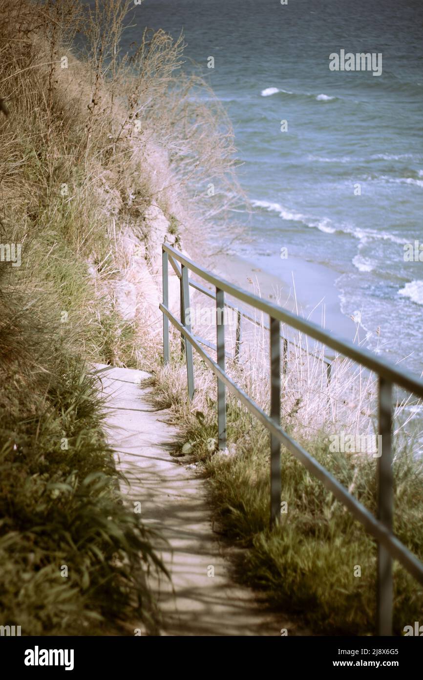 The walkway and stairs lead to the sea Stock Photo - Alamy