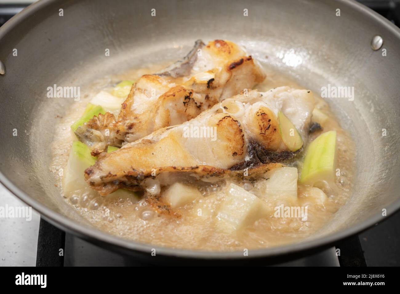home cooked fried fish on a wok Stock Photo - Alamy