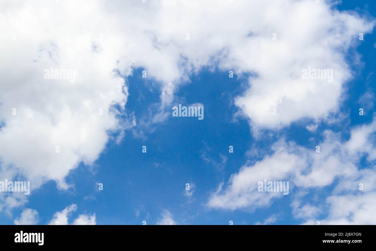 Summer sky. Cumulus clouds on a blue background. Partly cloudy. Dark ...