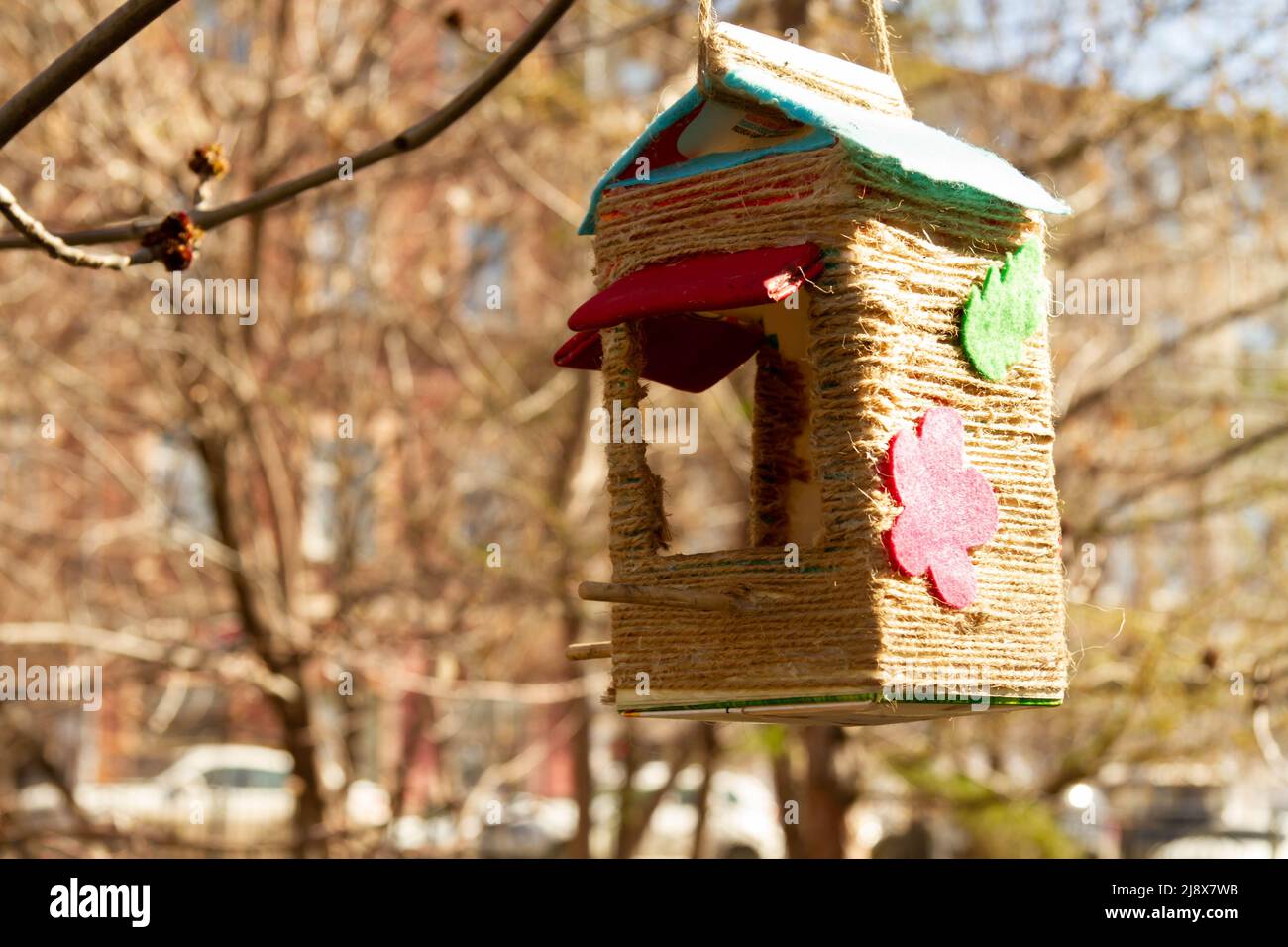 Bird feeders. Feeding birds in the forest. Birdhouse on a tree. Caring ...
