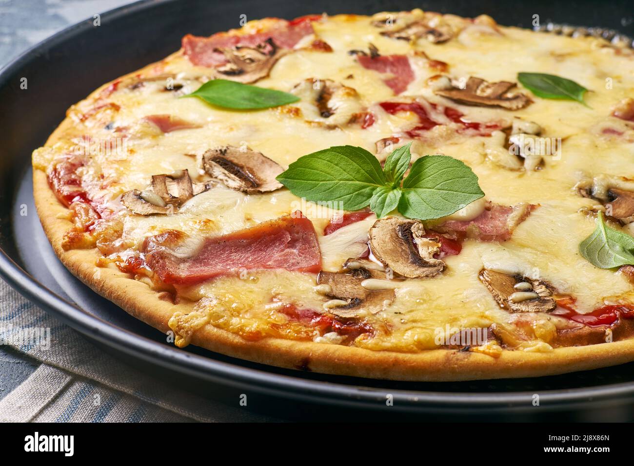 Homemade pizza with ham and mushroom close up Stock Photo - Alamy