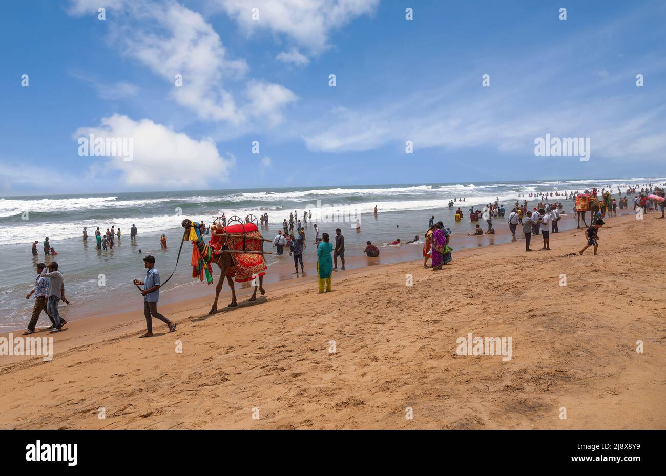 Crowded sea shore with tourists enjoying a bath at Puri beach at Odisha ...