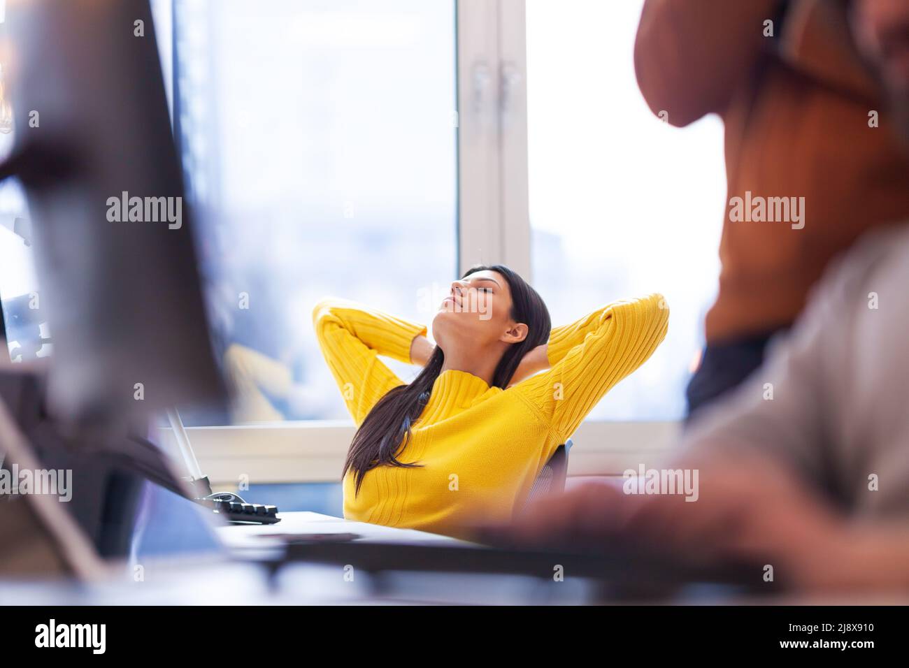 Girl taking a break during work in modern coworking office space ...