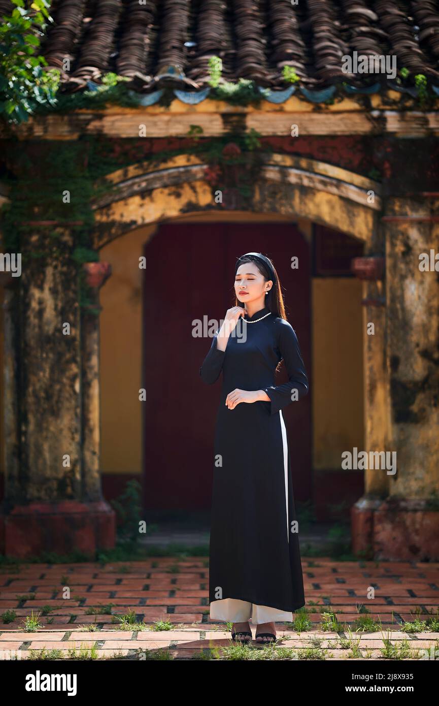 Ho Chi Minh city, Viet Nam: Vietnamese girl going to pagoda in ao dai ...