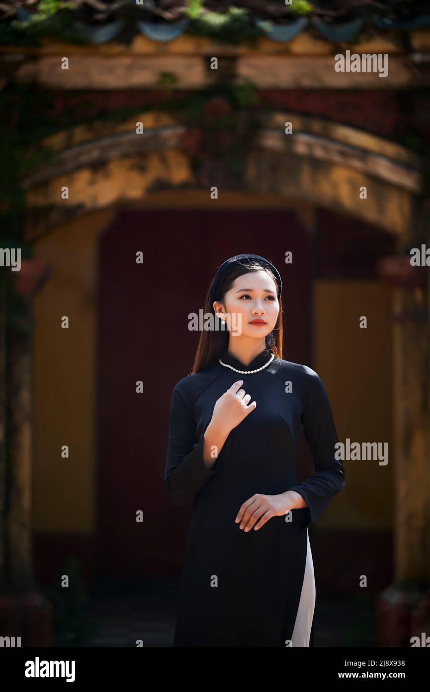 Ho Chi Minh city, Viet Nam: Vietnamese girl going to pagoda in ao dai ...