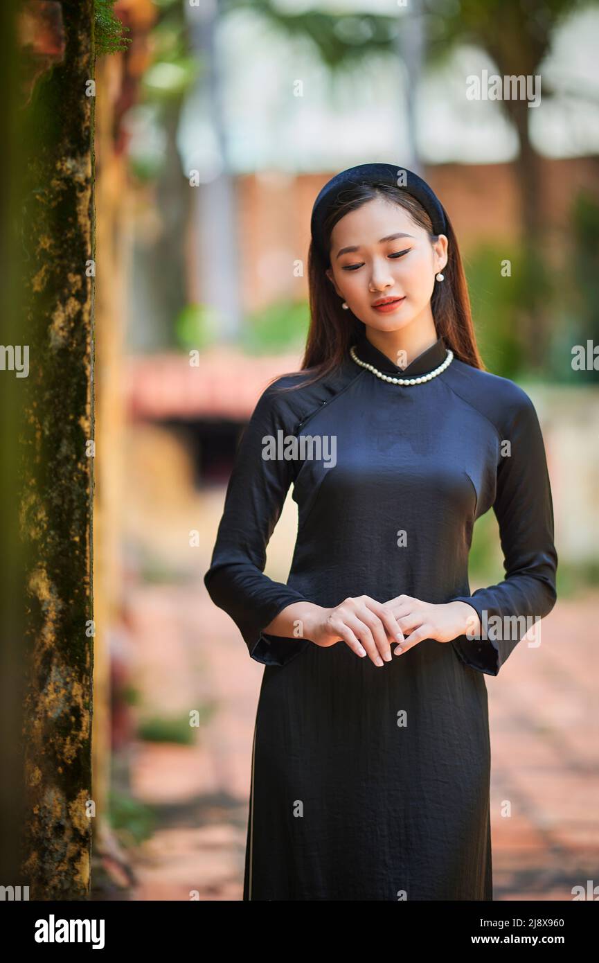 Ho Chi Minh city, Viet Nam: Vietnamese girl going to pagoda in ao dai ...