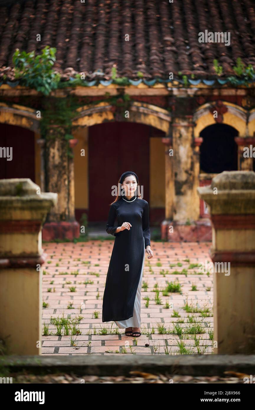 Ho Chi Minh city, Viet Nam: Vietnamese girl going to pagoda in ao dai ...
