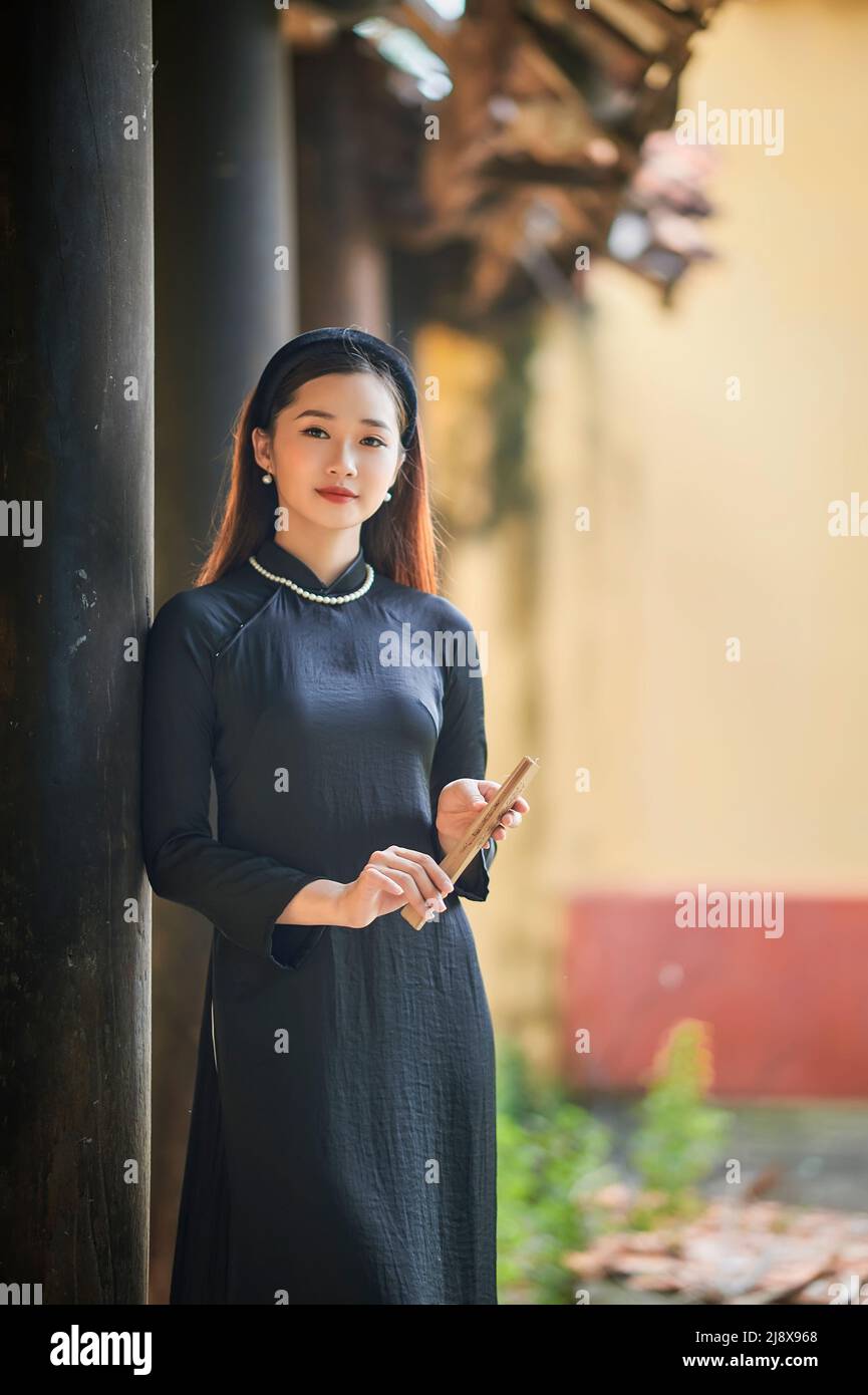Ho Chi Minh city, Viet Nam: Vietnamese girl going to pagoda in ao dai ...