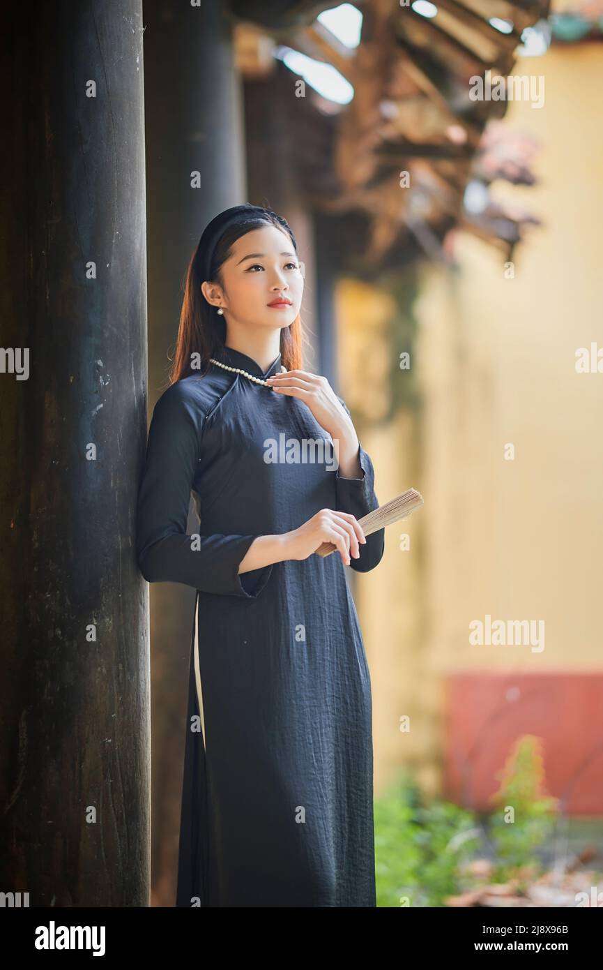 Ho Chi Minh city, Viet Nam: Vietnamese girl going to pagoda in ao dai ...