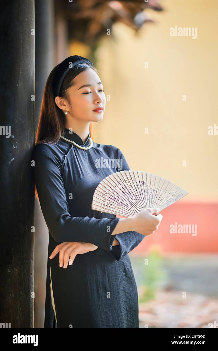 Ho Chi Minh city, Viet Nam: Vietnamese girl going to pagoda in ao dai ...