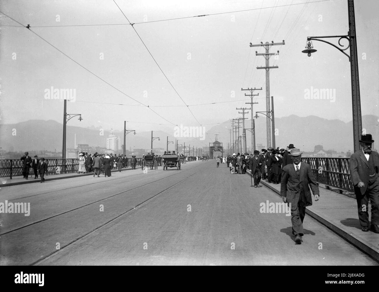 Pedestrians and carriages on Connaught Bridge (Cambie Street Bridge) in ...