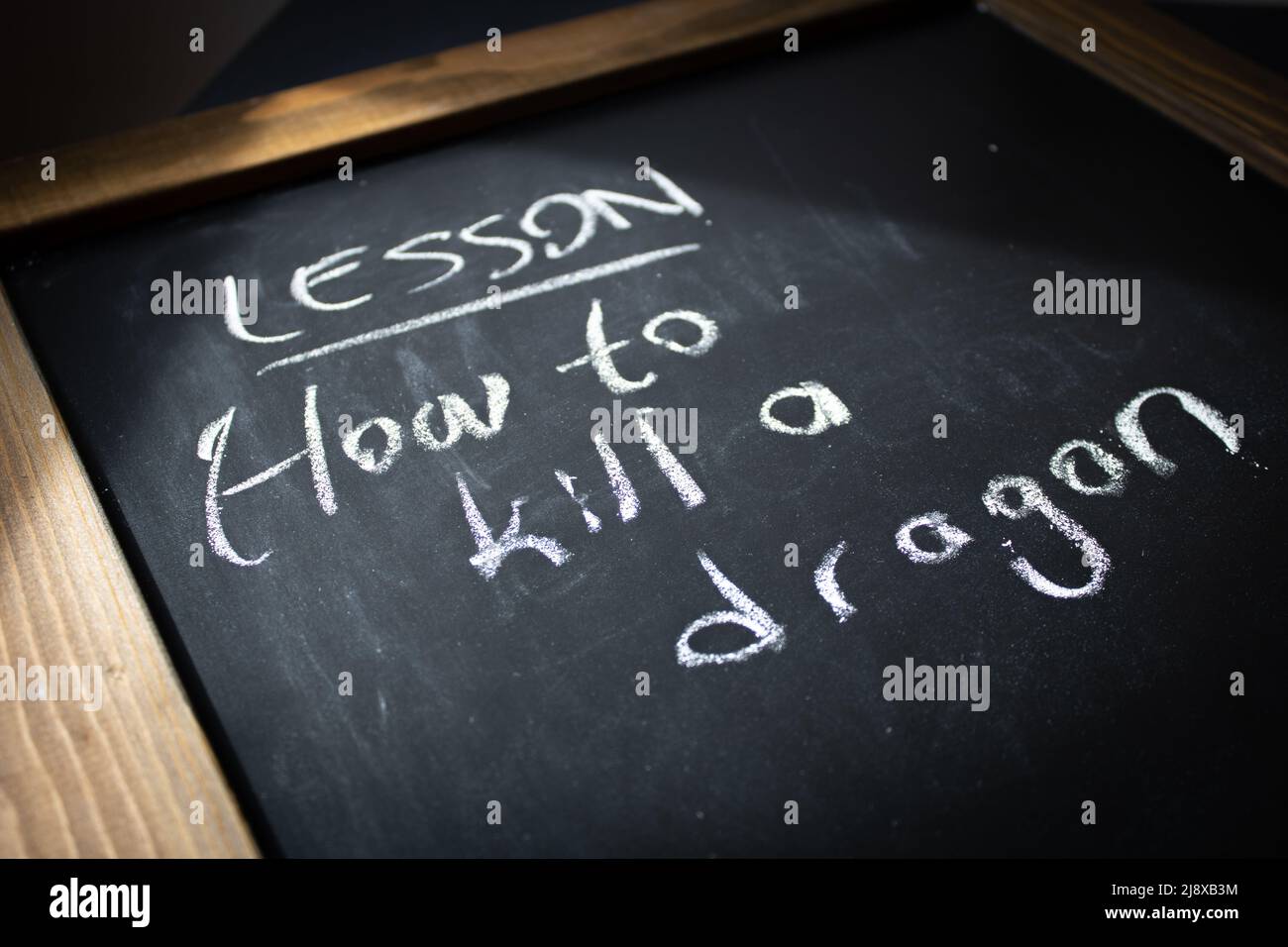 How to kill a dragon on a chalkboard Stock Photo - Alamy