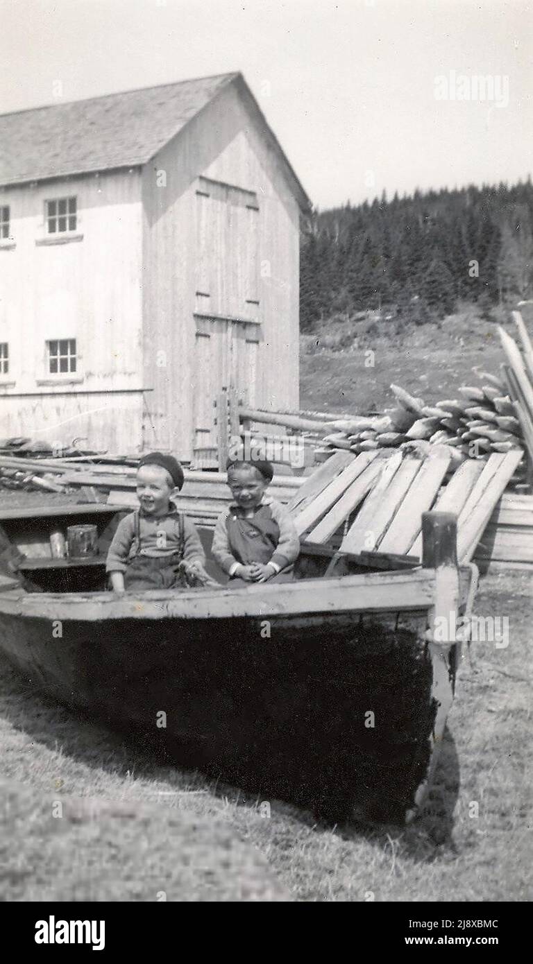 Two children, Cap-aux-Os, Gaspé, Quebec - Two boys sitting in a boat ...